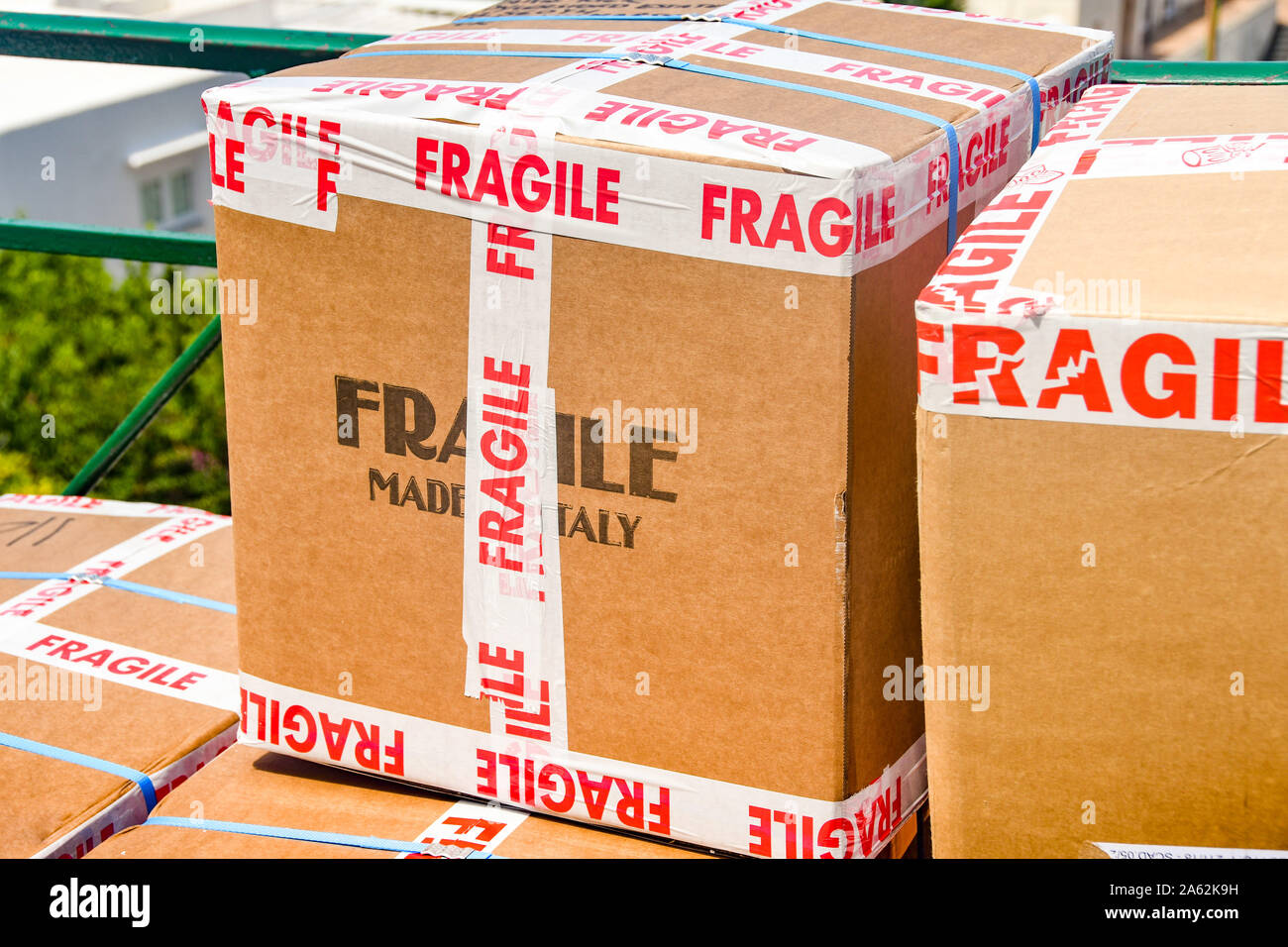Cardboard boxes secured with sticky tape marked "Fragile Stock Photo - Alamy