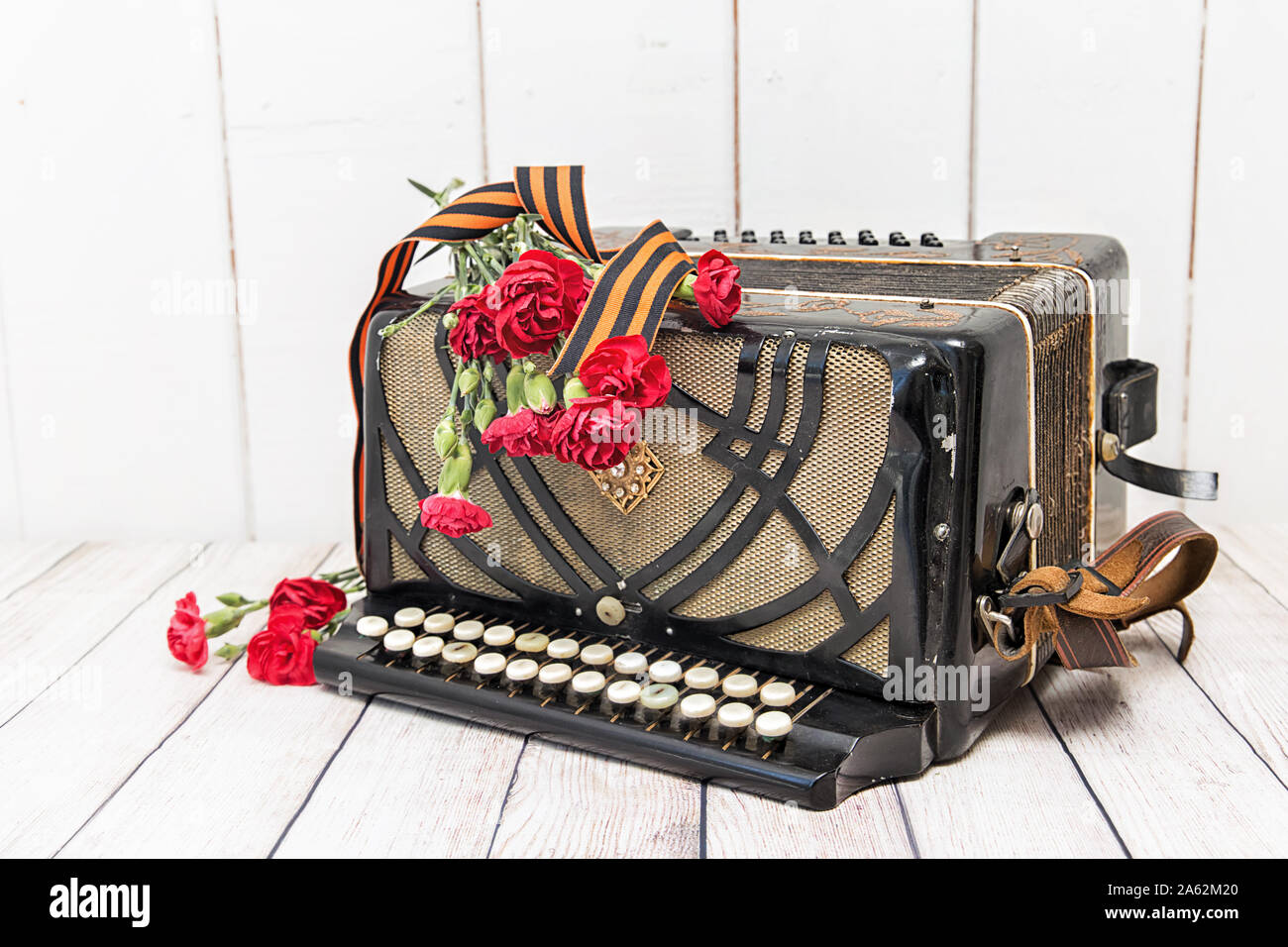 Accordion, red carnations and St. George ribbon. Victory Day. May 9 ...