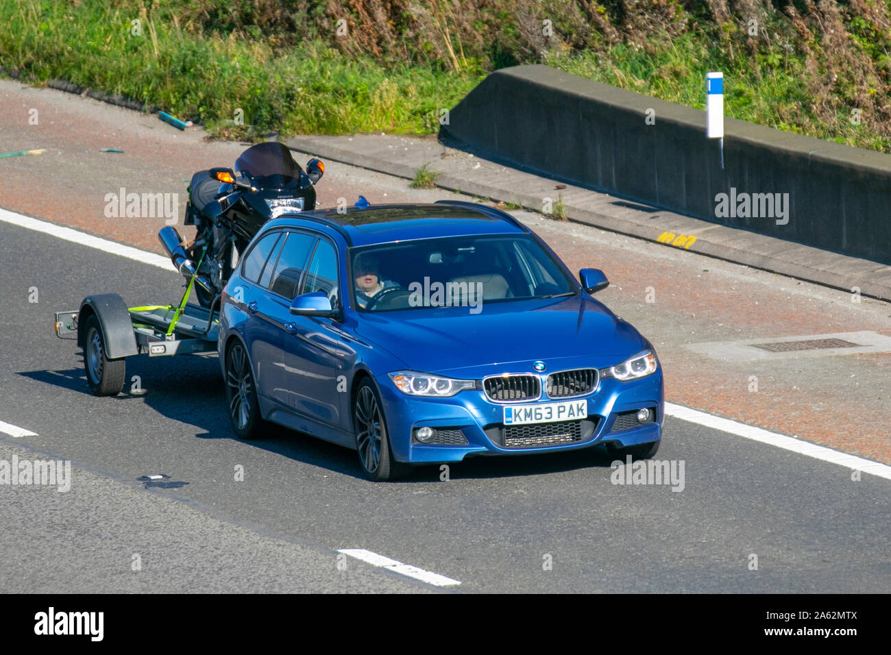 2014 blue BMW 320D M Sport Touring car towing bike trailer; UK Vehicular traffic, transport ...
