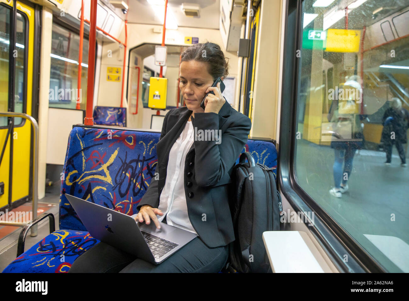 A woman works up, from the road to work, on the road, mobile, subway ...