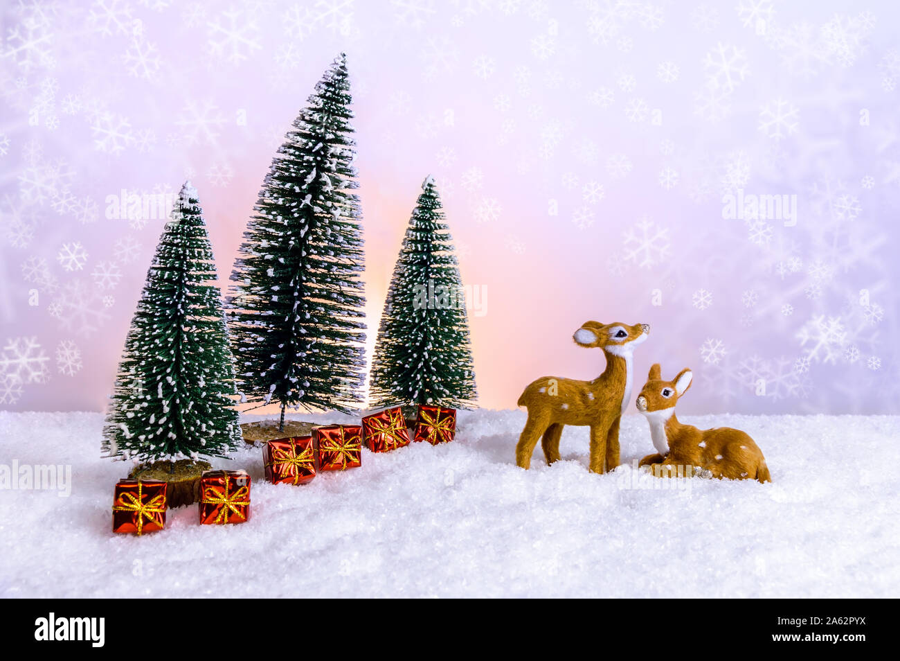 Christmas holiday theme with miniature cute reindeers, fir trees and ...