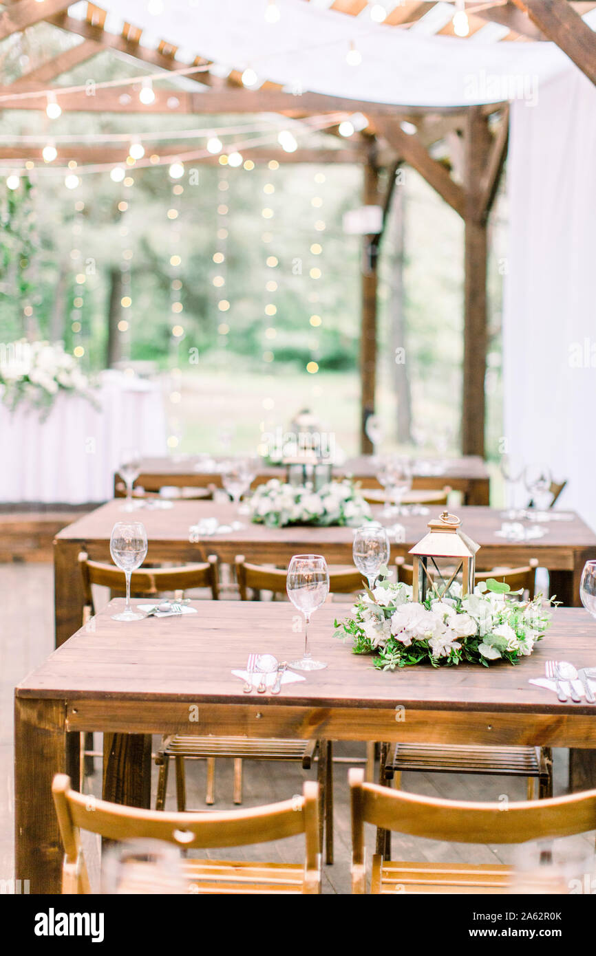 Rustic style wedding wooden decorated tables outdoors. Decorations made ...
