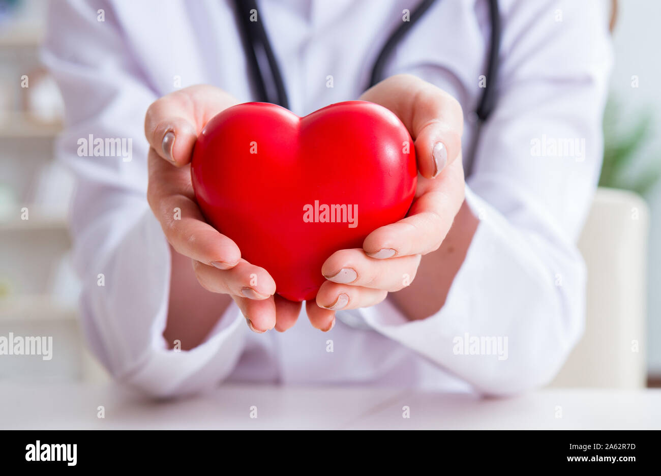 The doctor cardiologist with red heart in the hospital Stock Photo - Alamy