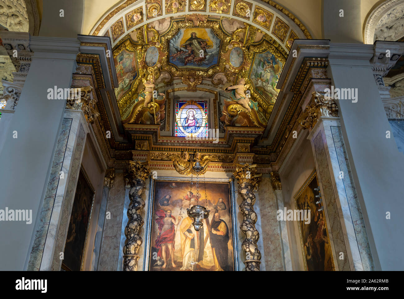 A stained glass window above one of the 10 interior chapels inside the ...