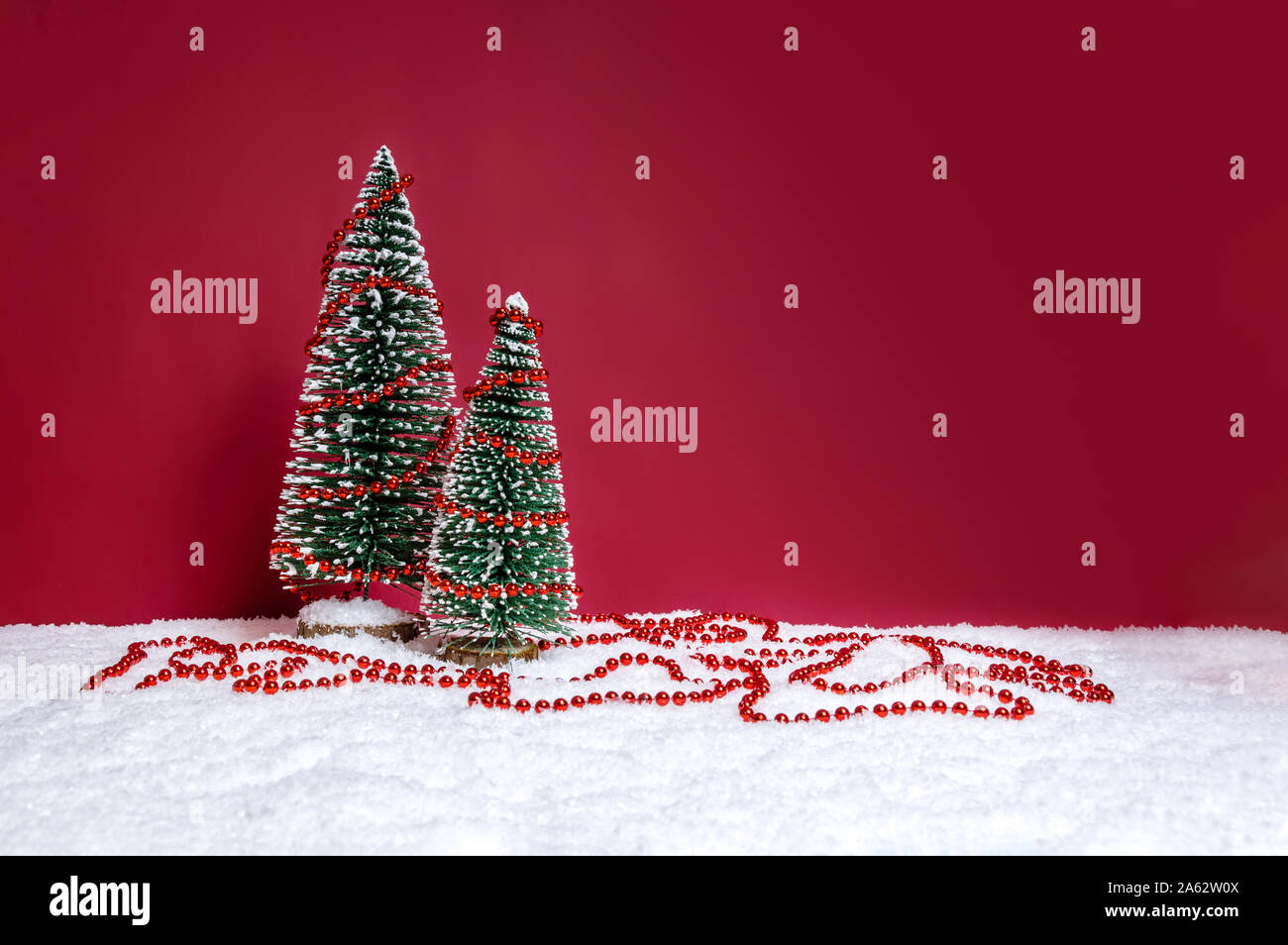 Christmas holiday theme with two small Christmas trees decorated with ...
