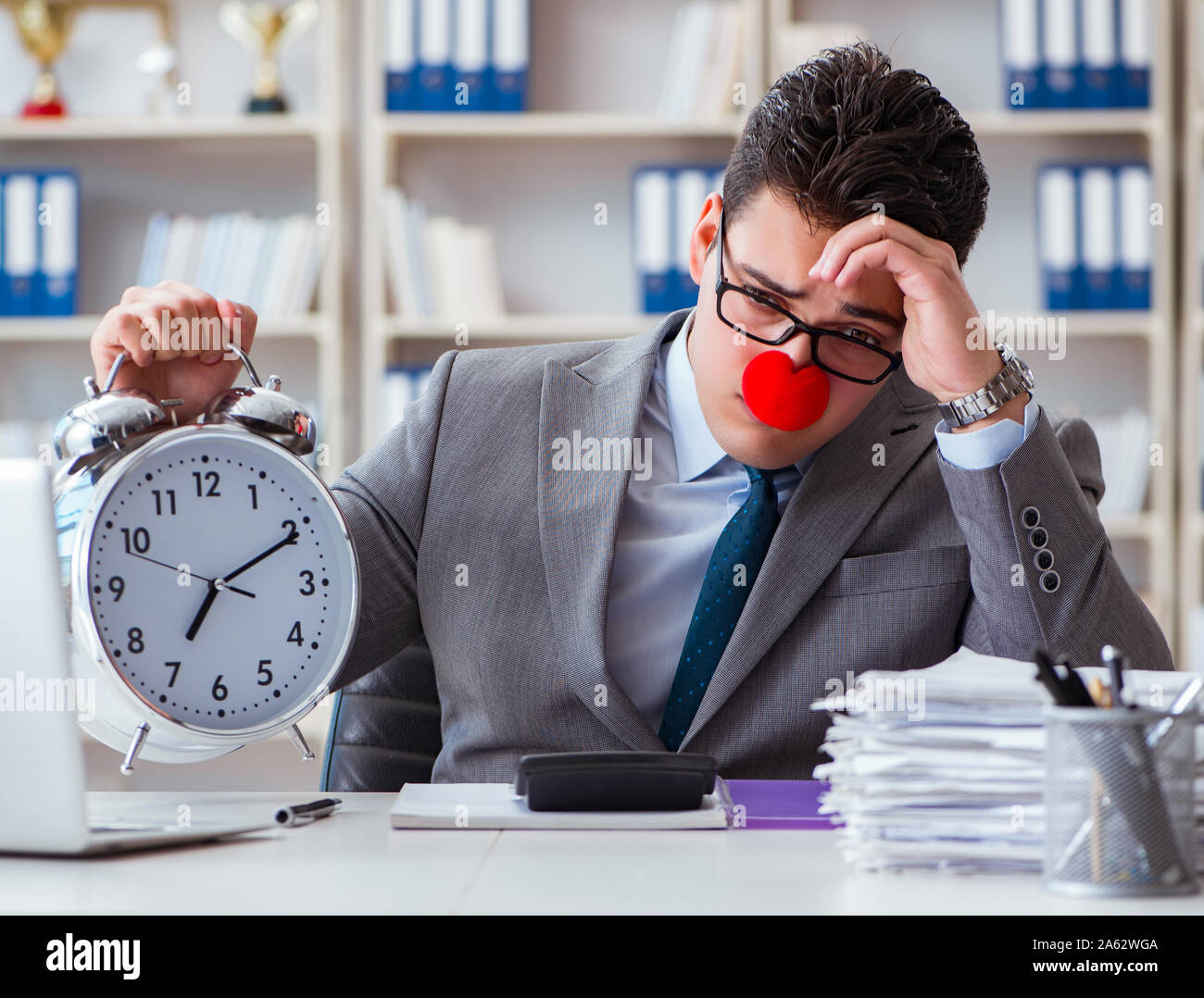 The clown businessman with alarm clock missing dieadline Stock Photo ...