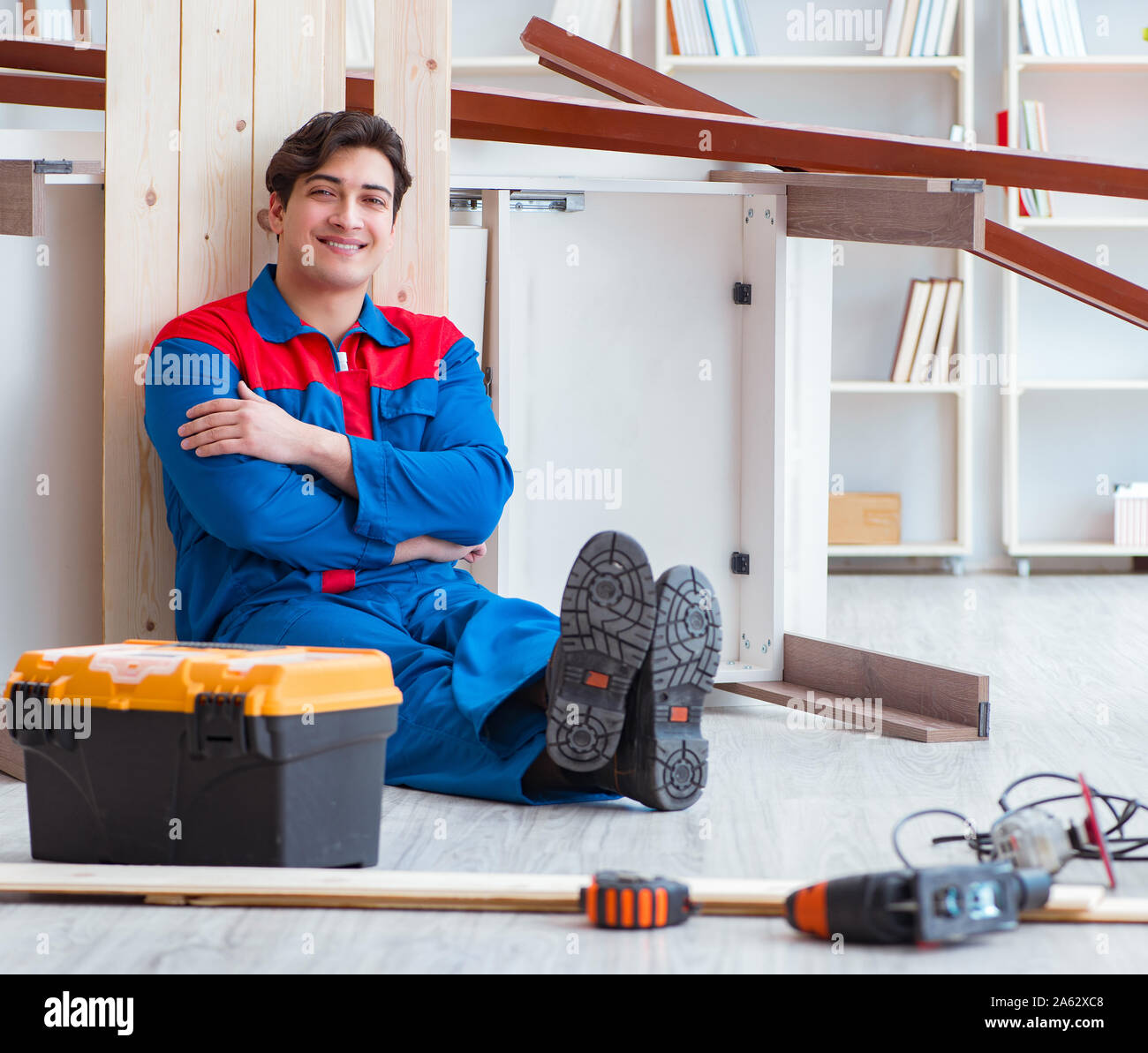 The young carpenter taking break from working with wooden planks Stock ...