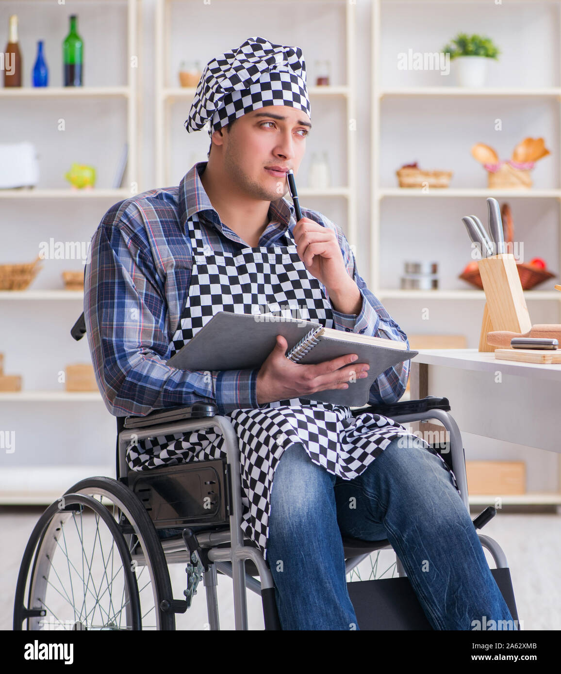 The young man cook with book of food recipes Stock Photo - Alamy
