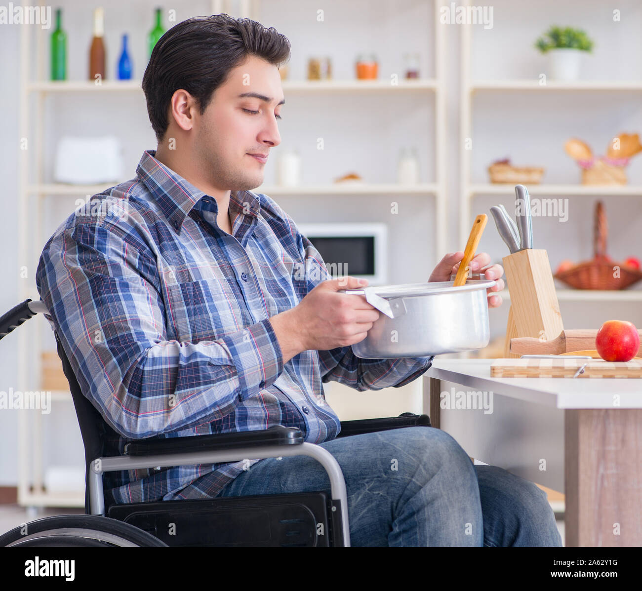 The disabled man preparing soup at kitchen Stock Photo - Alamy