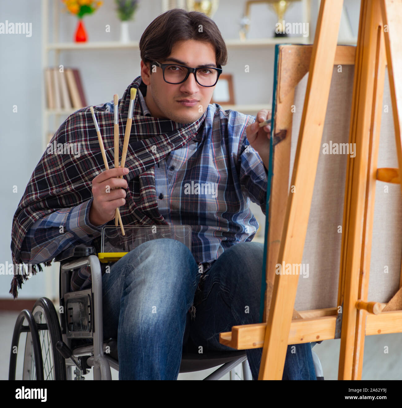 The disabled artist painting picture in studio Stock Photo - Alamy