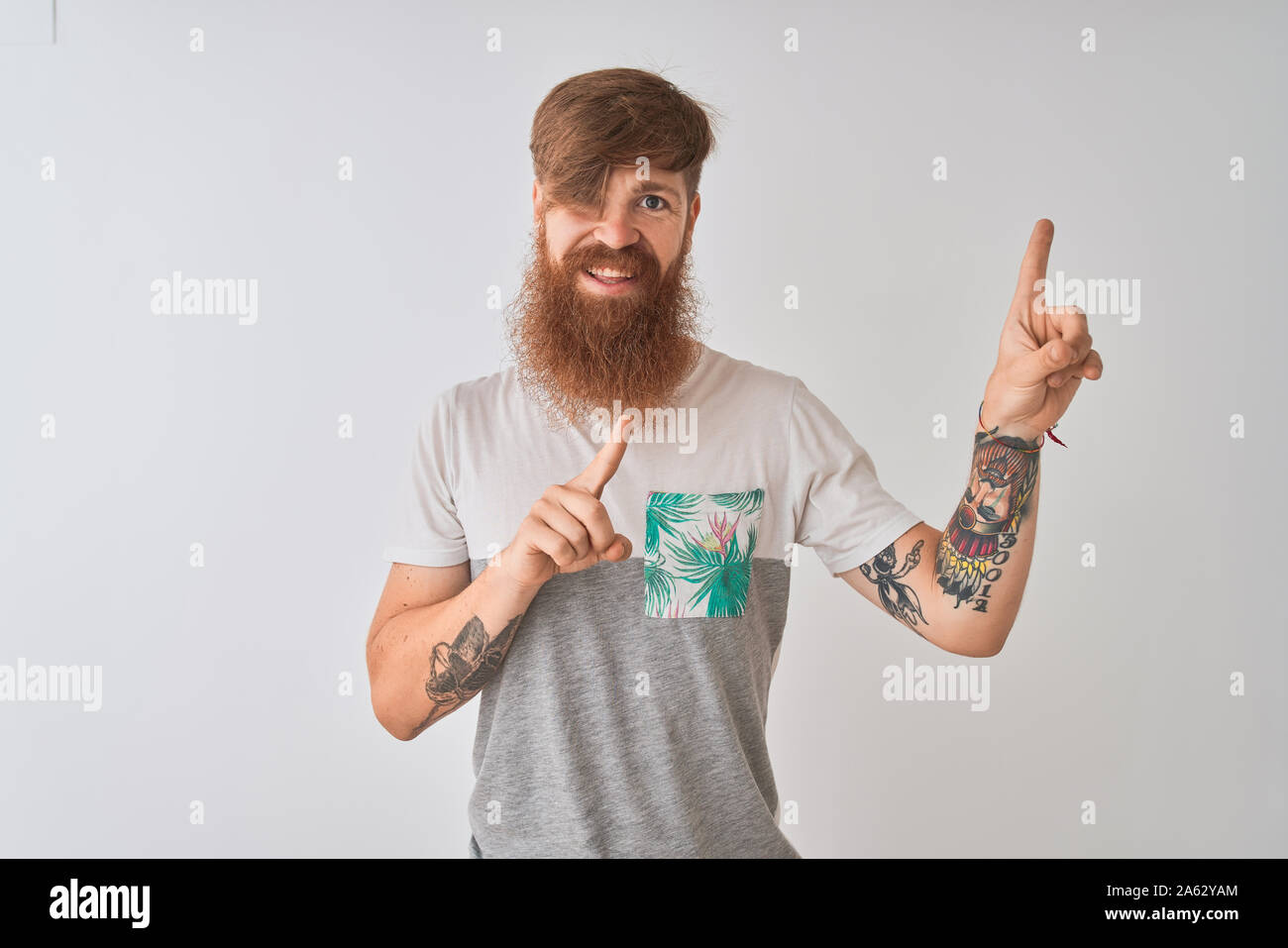 Young redhead irish man wearing t-shirt standing over isolated white ...