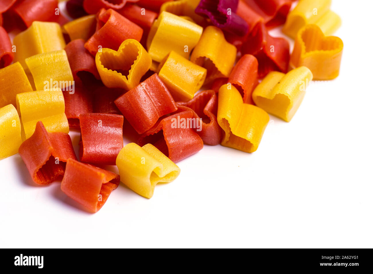 Colorful heart shaped macaroni pasta flat lay isolated Stock Photo - Alamy