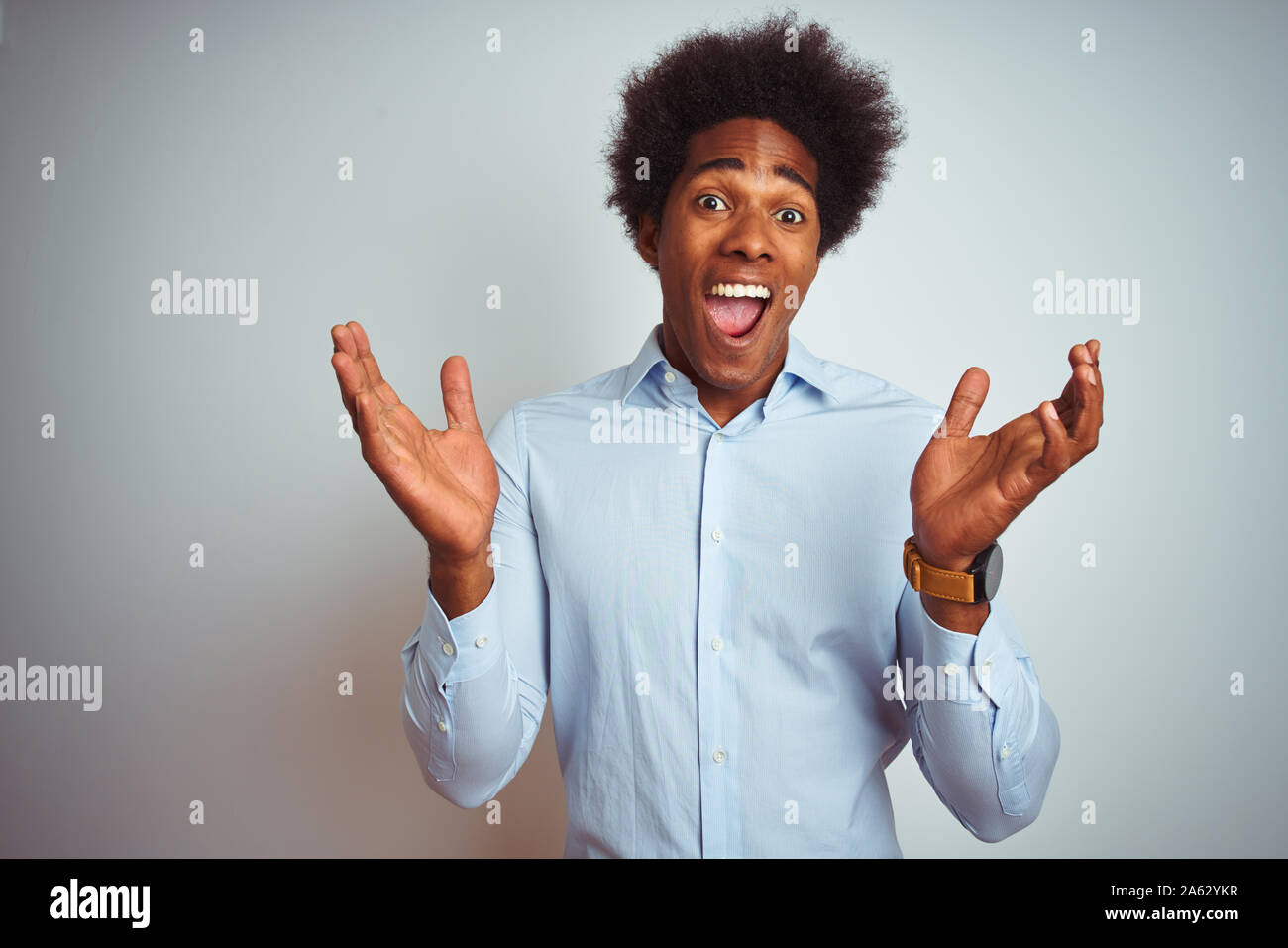 Young african american man with afro hair wearing elegant shirt over ...