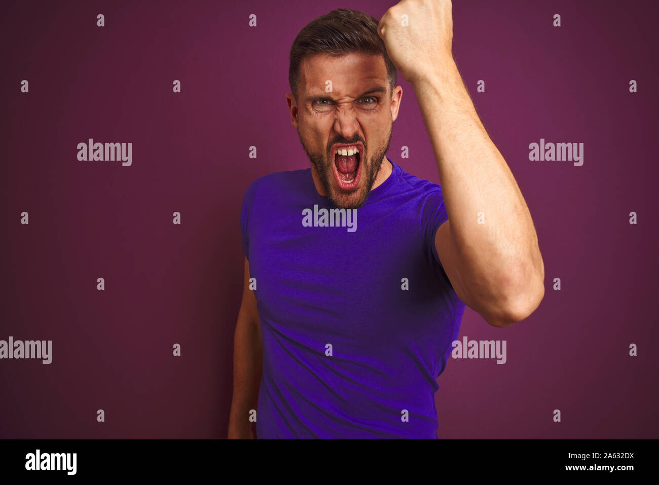 Young man wearing casual purple t-shirt over lilac isolated background ...