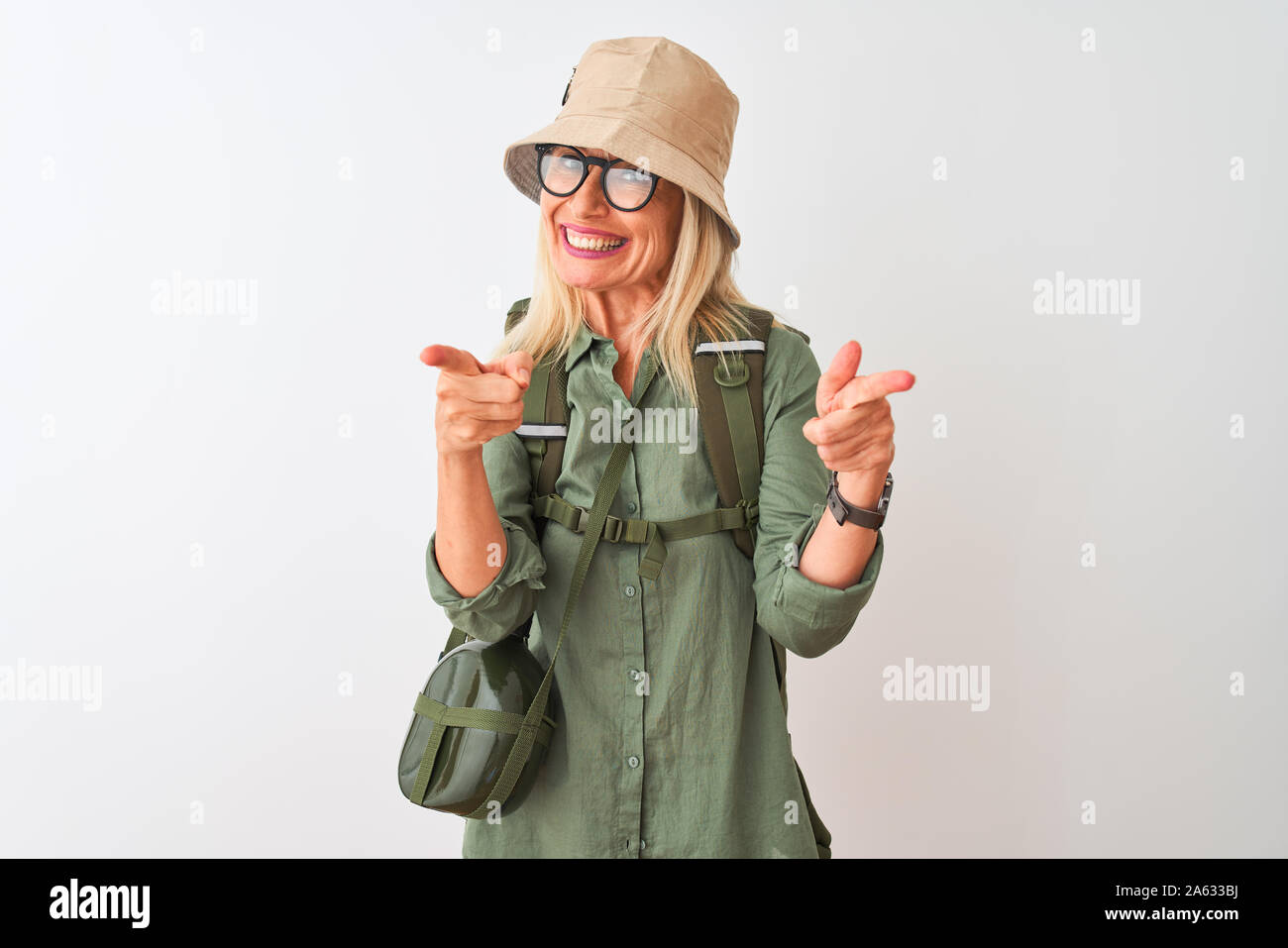 Middle age hiker woman wearing backpack hat canteen glasses over ...