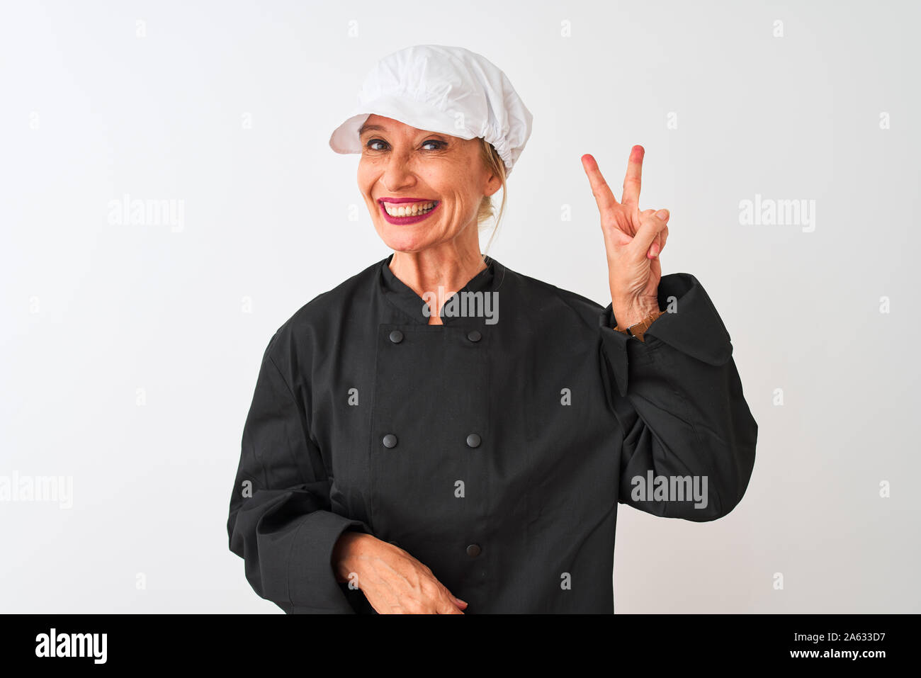 Middle age chef woman wearing uniform and cap standing over isolated ...