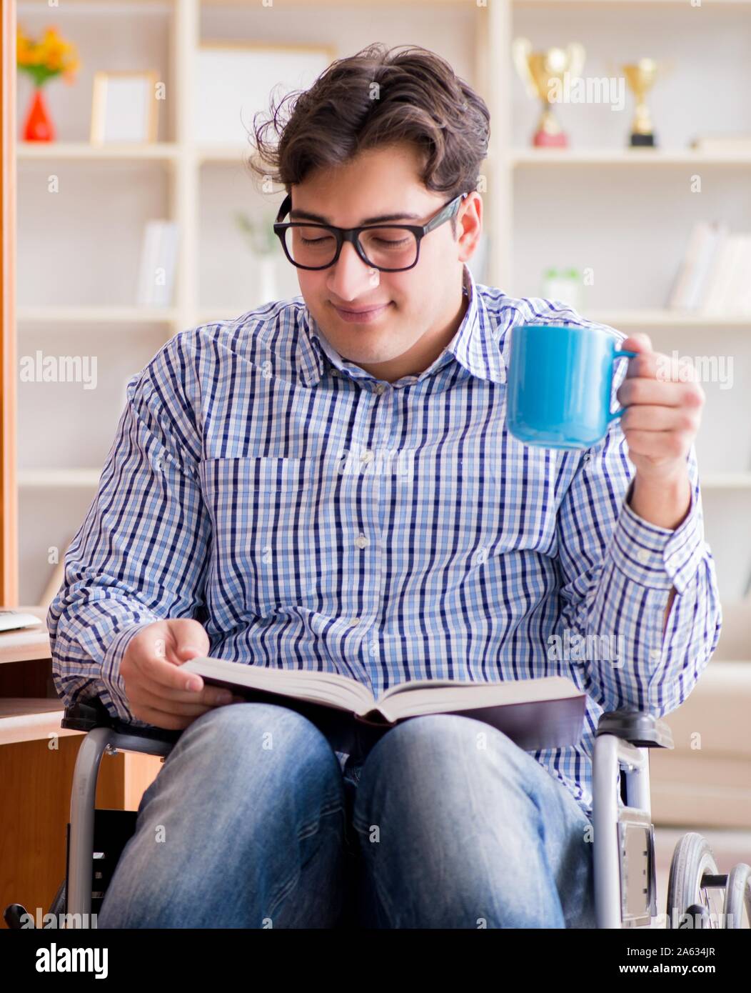 Disabled student studying at home on wheelchair Stock Photo - Alamy