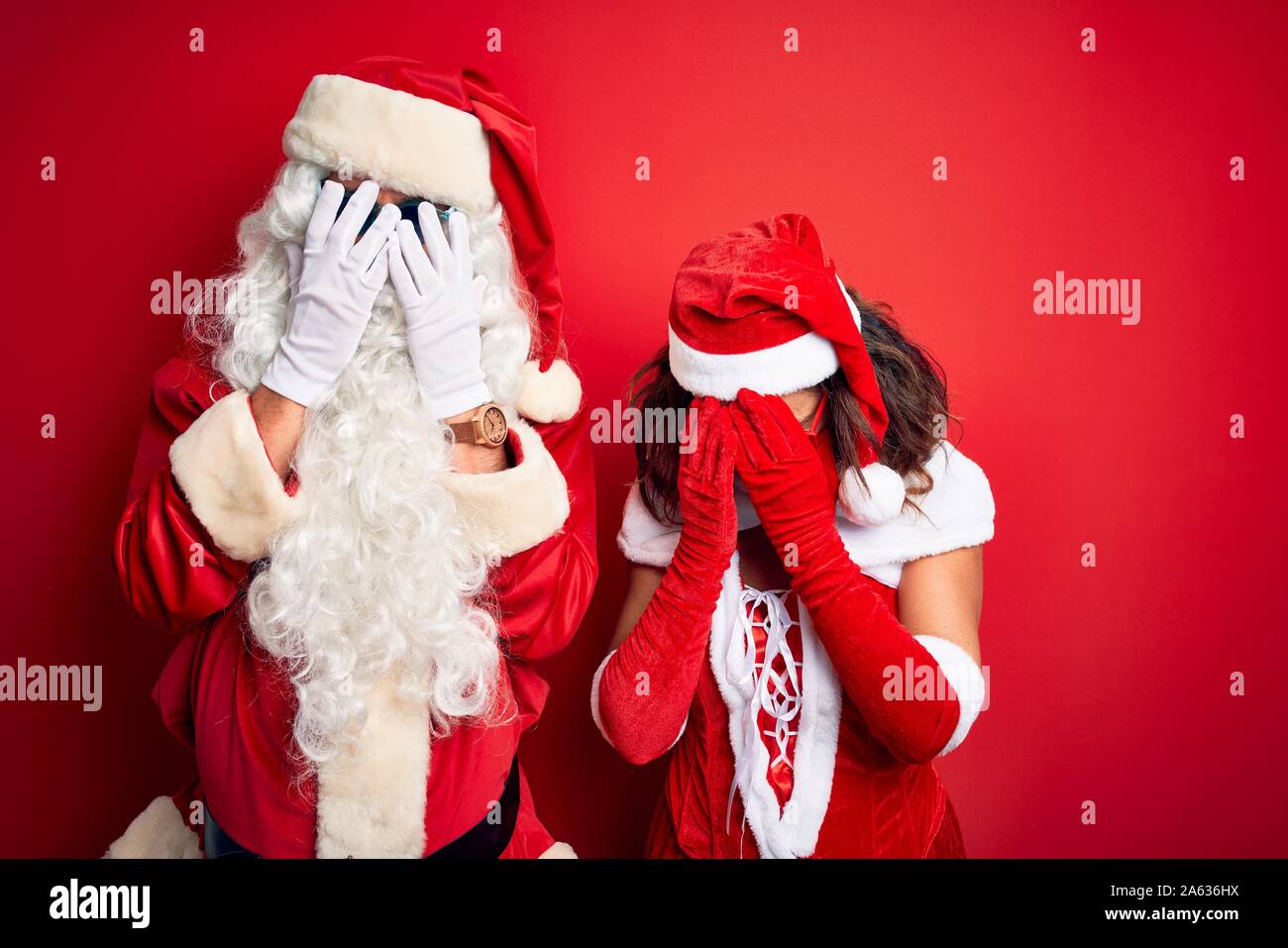 Middle age couple wearing Santa costume and sunglasses over isolated ...