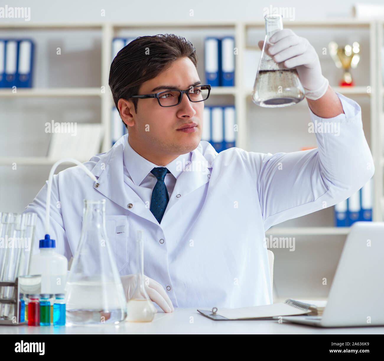 Young researcher scientist doing a water test contamination experiment ...