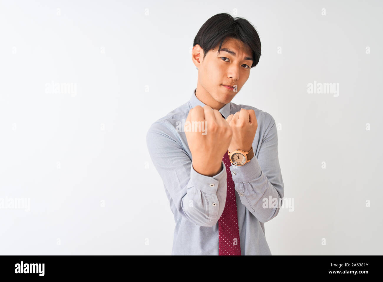 Chinese businessman wearing elegant tie standing over isolated white ...