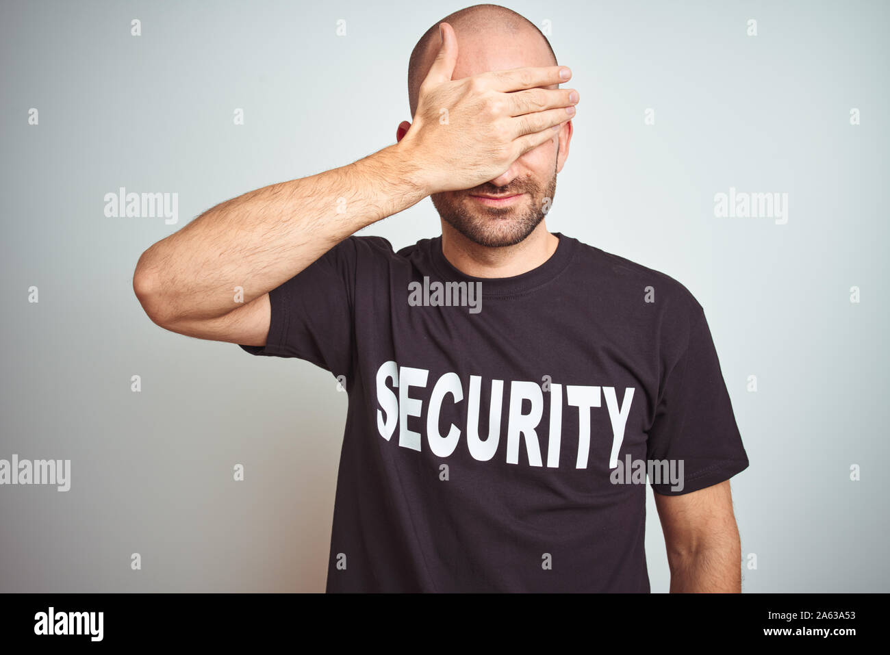 Young safeguard man wearing security uniform over isolated background ...