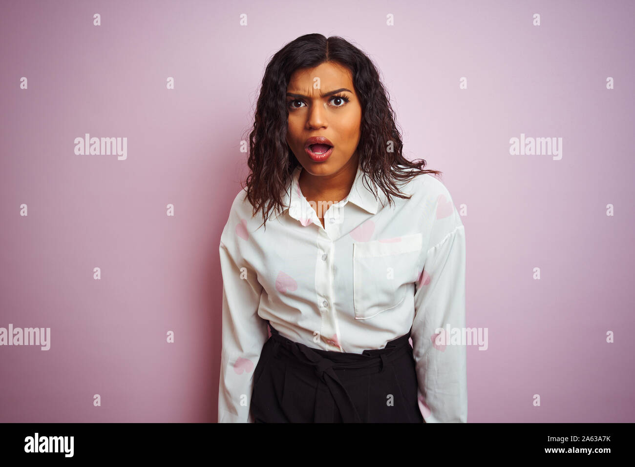 Transsexual transgender businesswoman standing over isolated pink ...