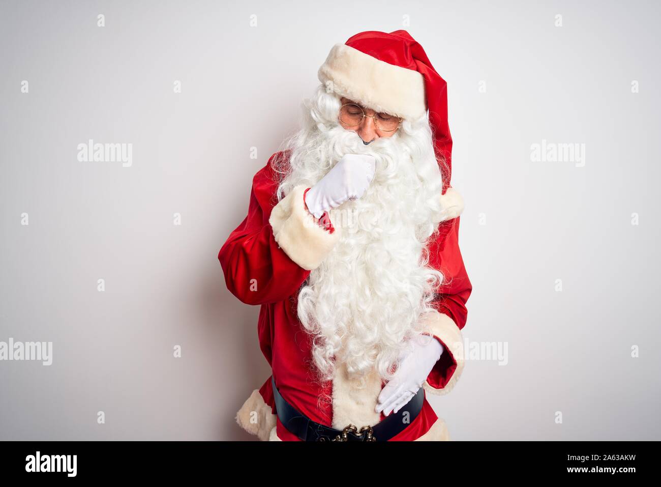 Middle age handsome man wearing Santa costume standing over isolated ...