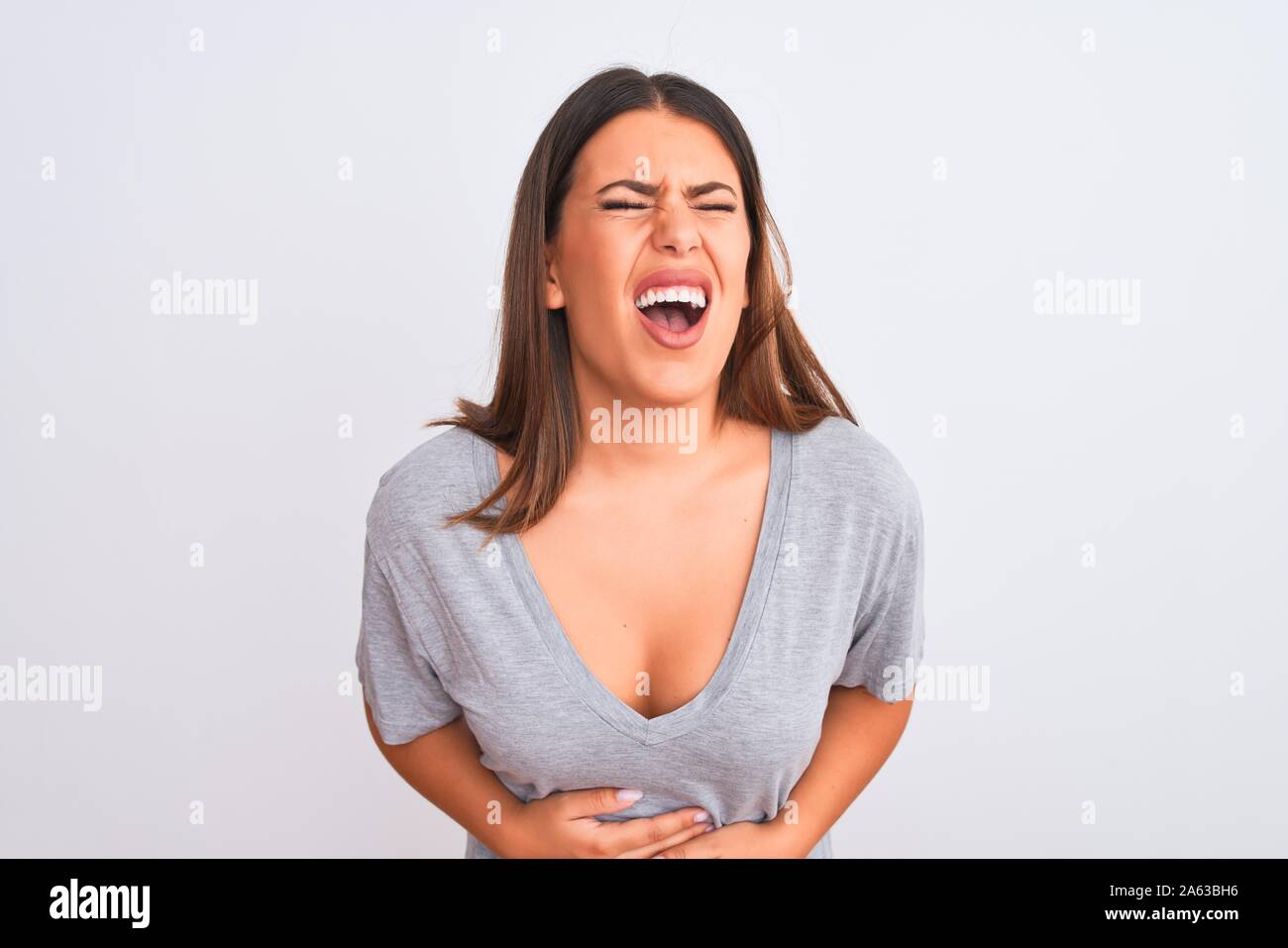 Portrait of beautiful young woman standing over isolated white ...