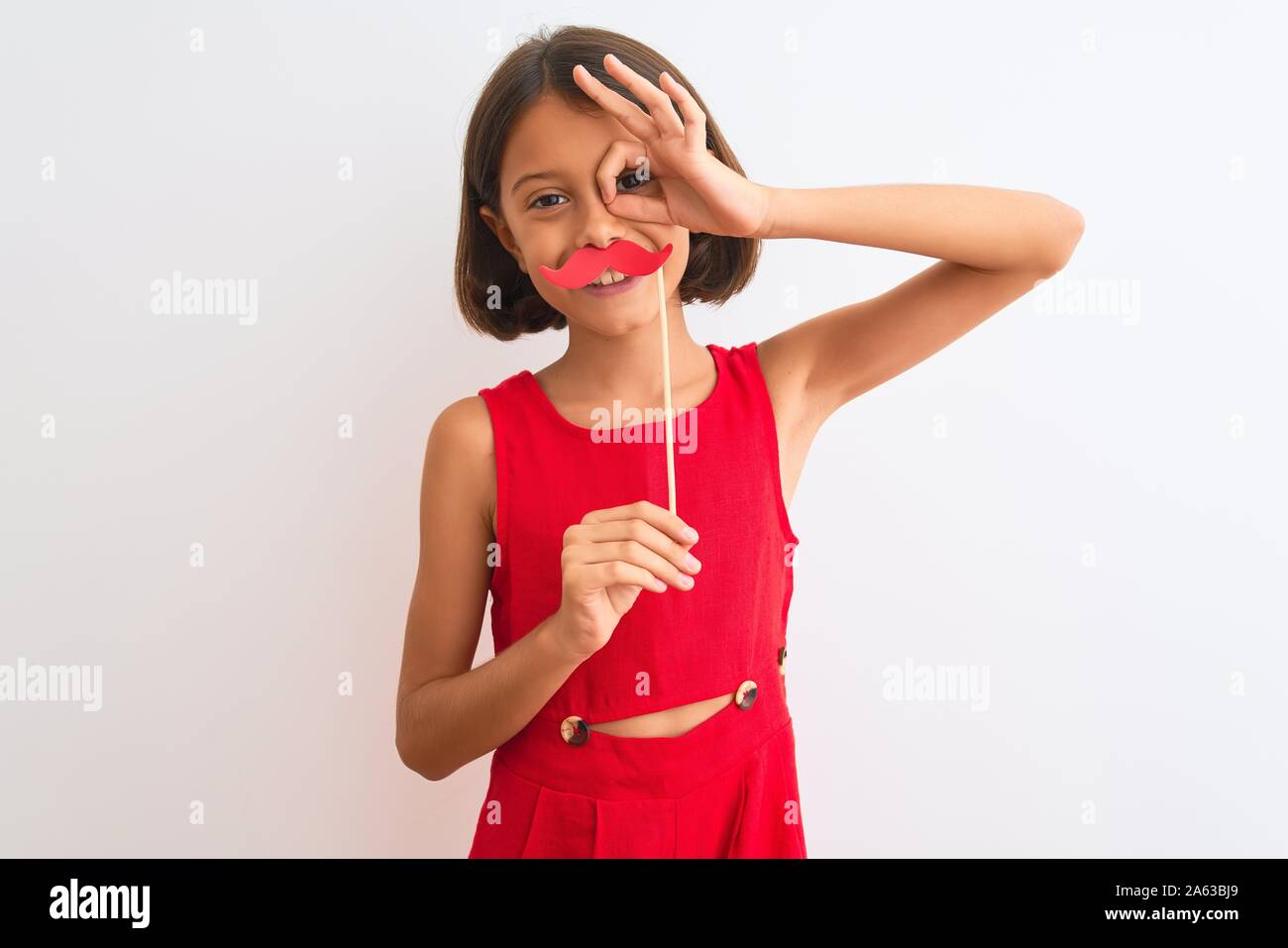Beautiful child girl holding fanny party mustache standing over ...