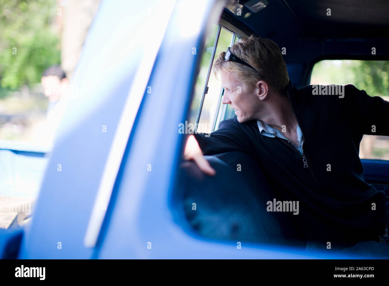 A blond man looking out his car window Stock Photo - Alamy
