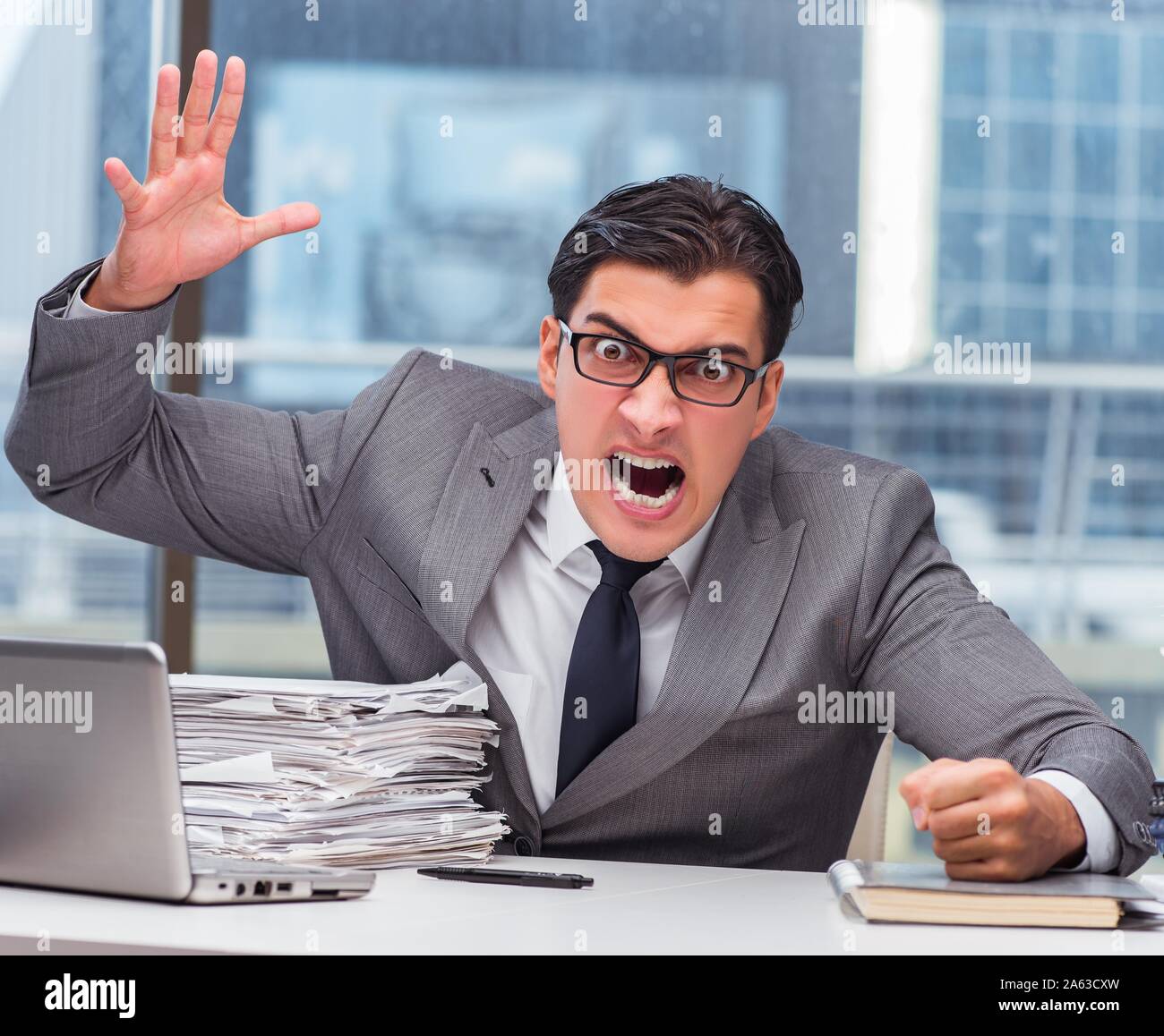 The angry businessman with too much work in office Stock Photo - Alamy