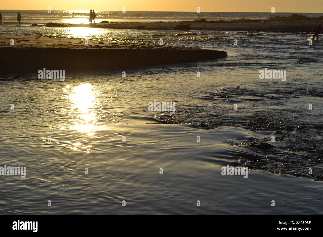 People enjoying Costa Rican beach at sundown Stock Photo - Alamy