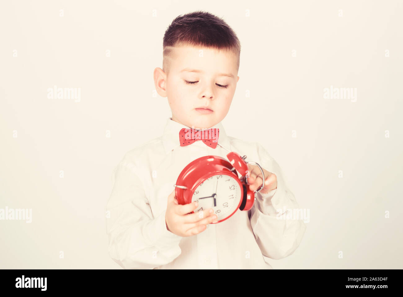 happy child with retro clock in bow tie. tuxedo kid. Happy childhood ...