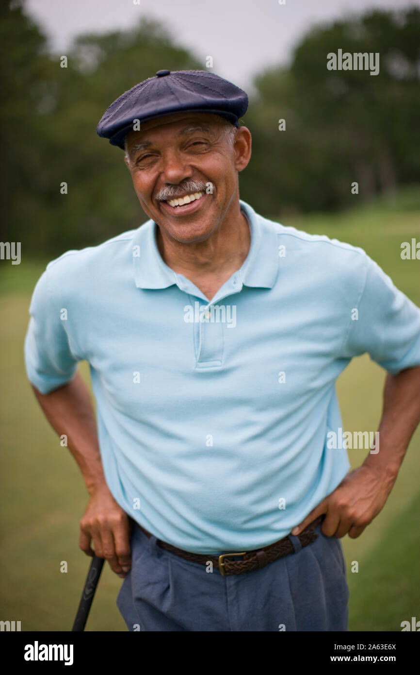 Portrait of a smiling senior man wearing a golf cap Stock Photo - Alamy