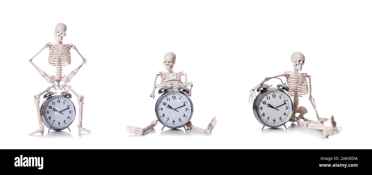 The skeleton with alarm clock on the white Stock Photo - Alamy