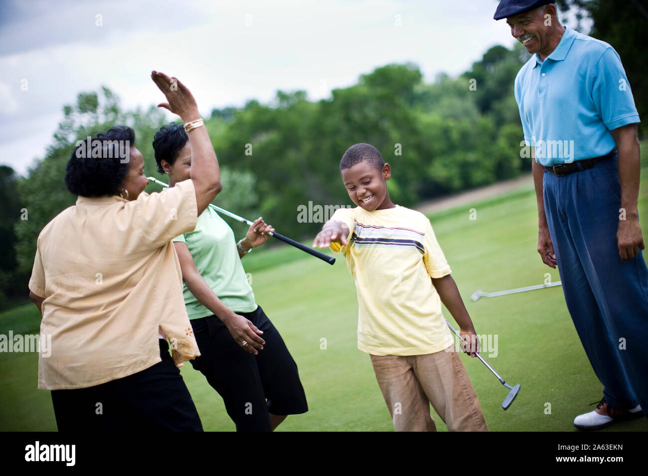 Family playing golf together Stock Photo - Alamy