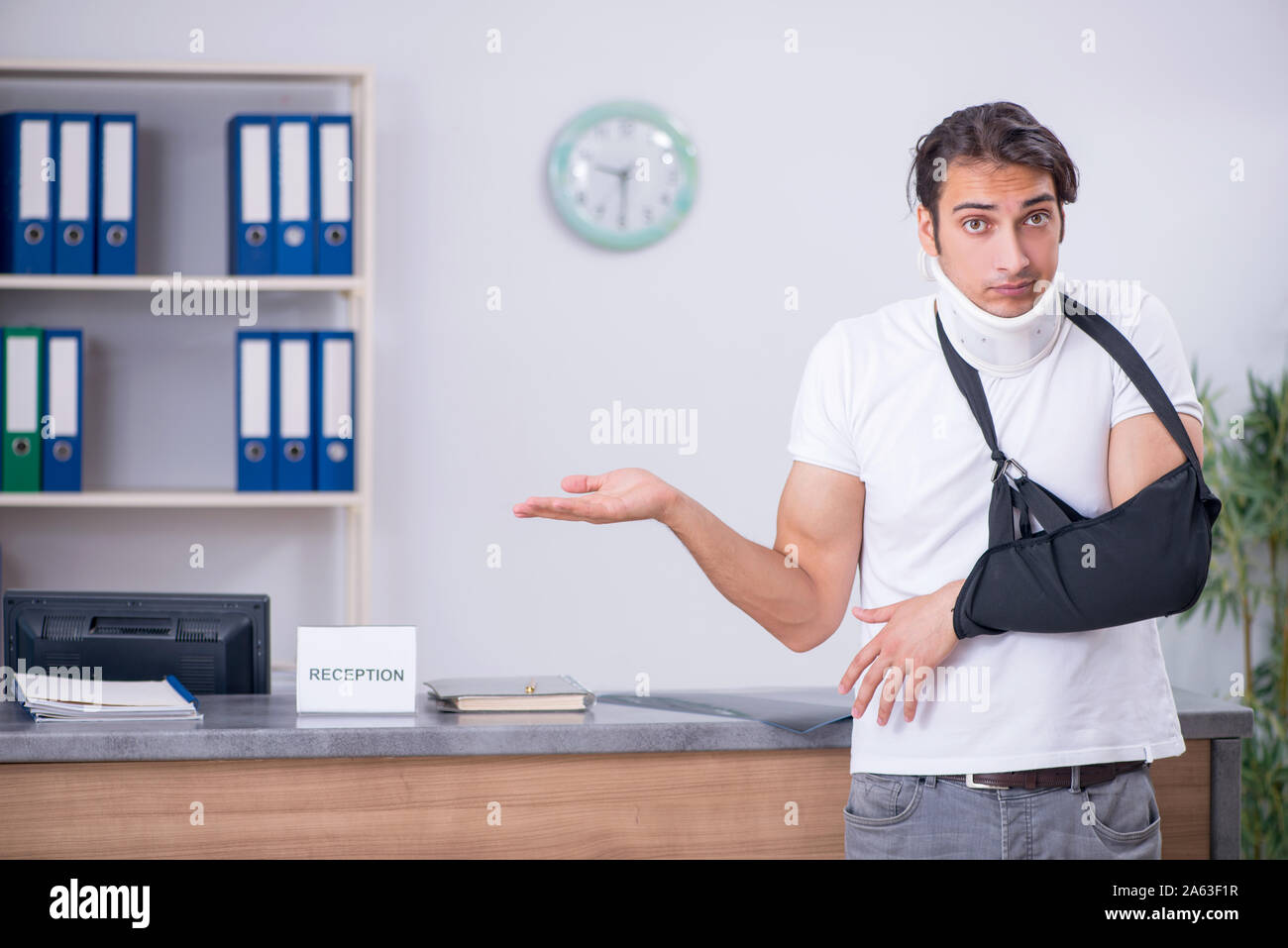 Clinic reception counter and young patient Stock Photo - Alamy
