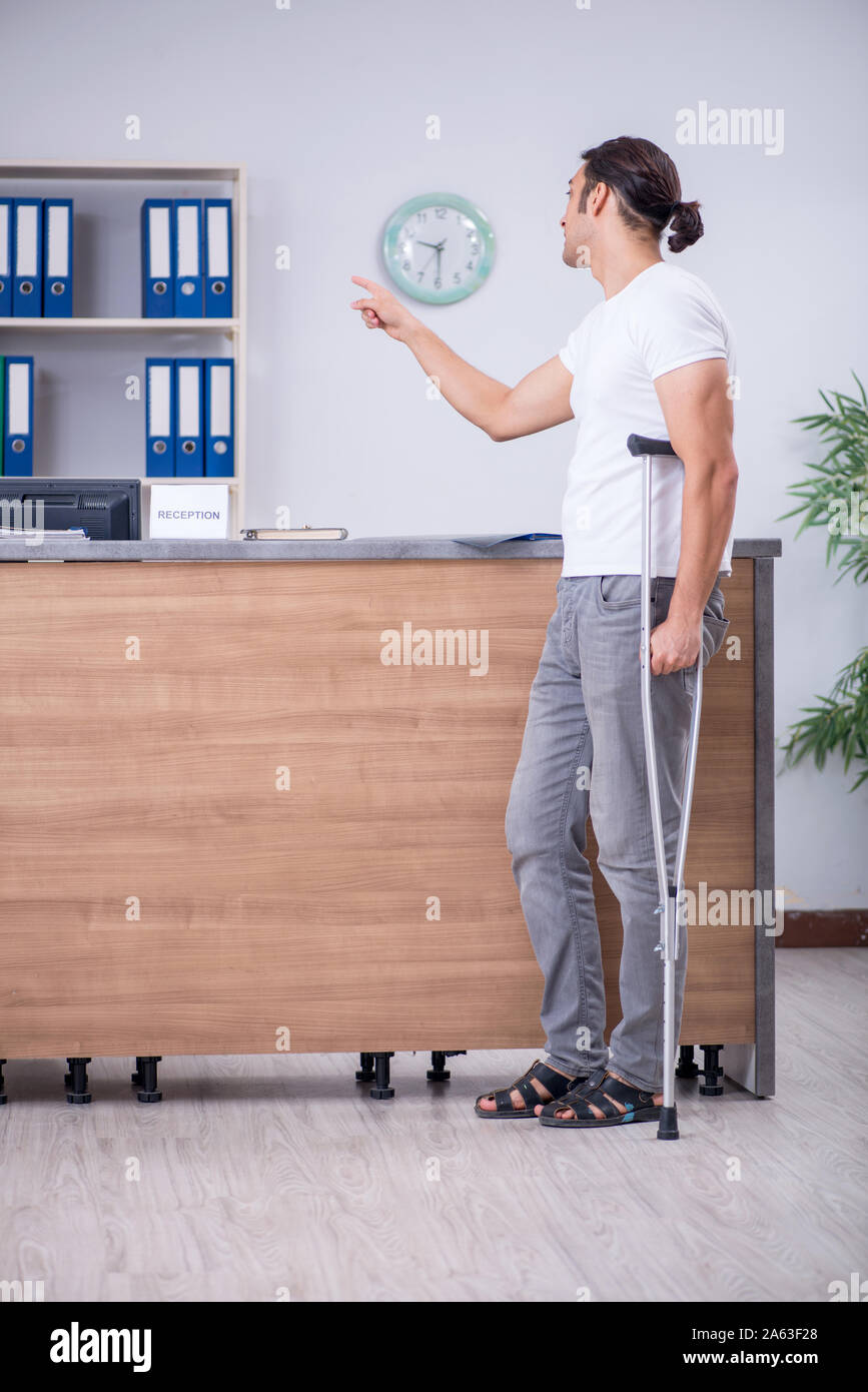 Clinic reception counter and young patient Stock Photo - Alamy