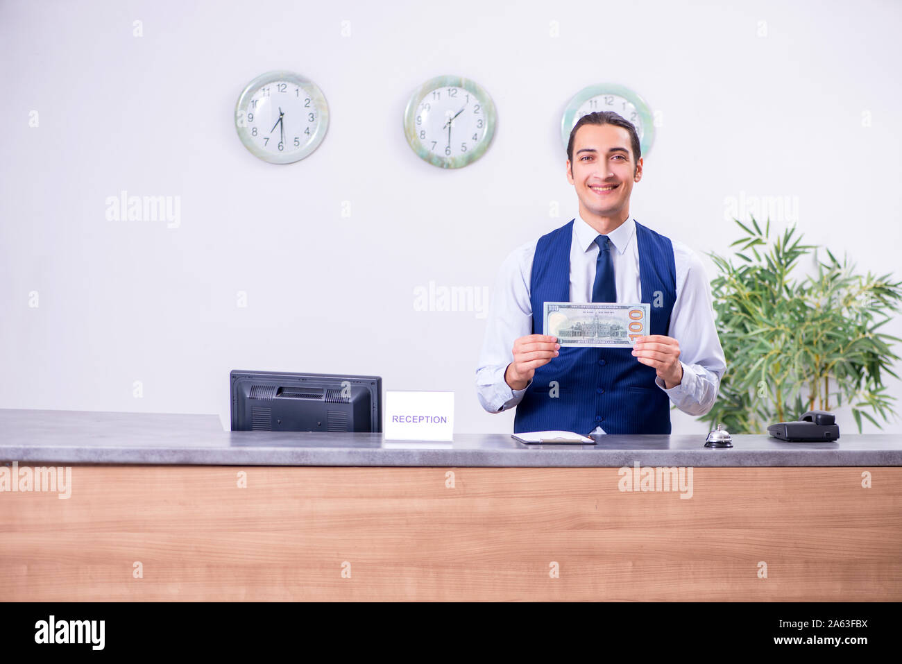 The young man receptionist at the hotel counter Stock Photo - Alamy
