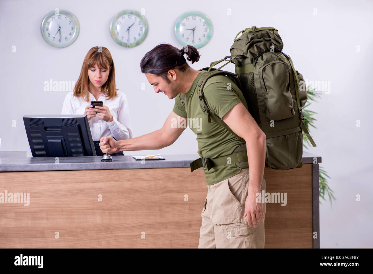 The young man at the hotel reception Stock Photo - Alamy