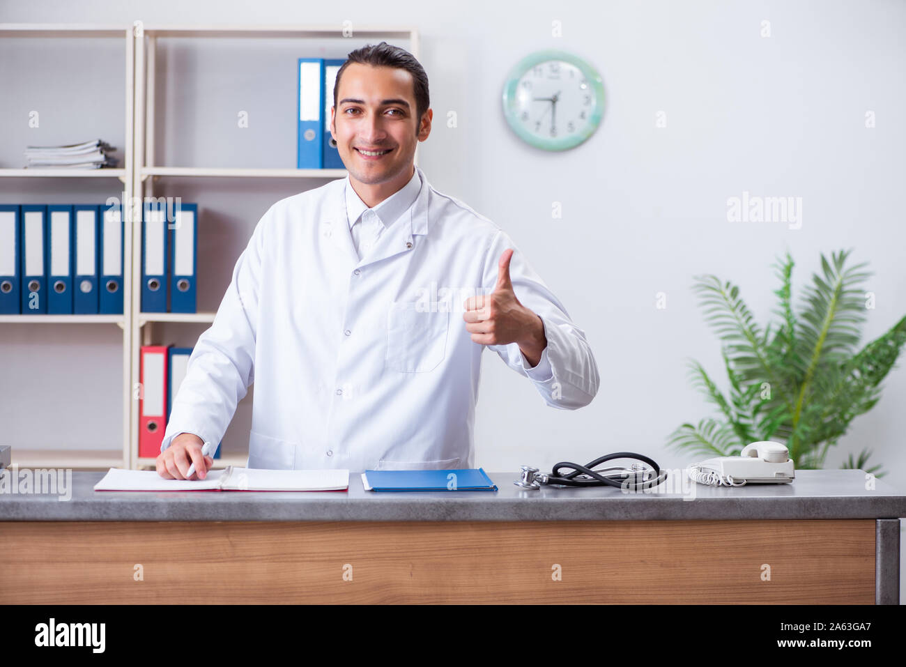 The young male doctor at the reception in the hospital Stock Photo - Alamy