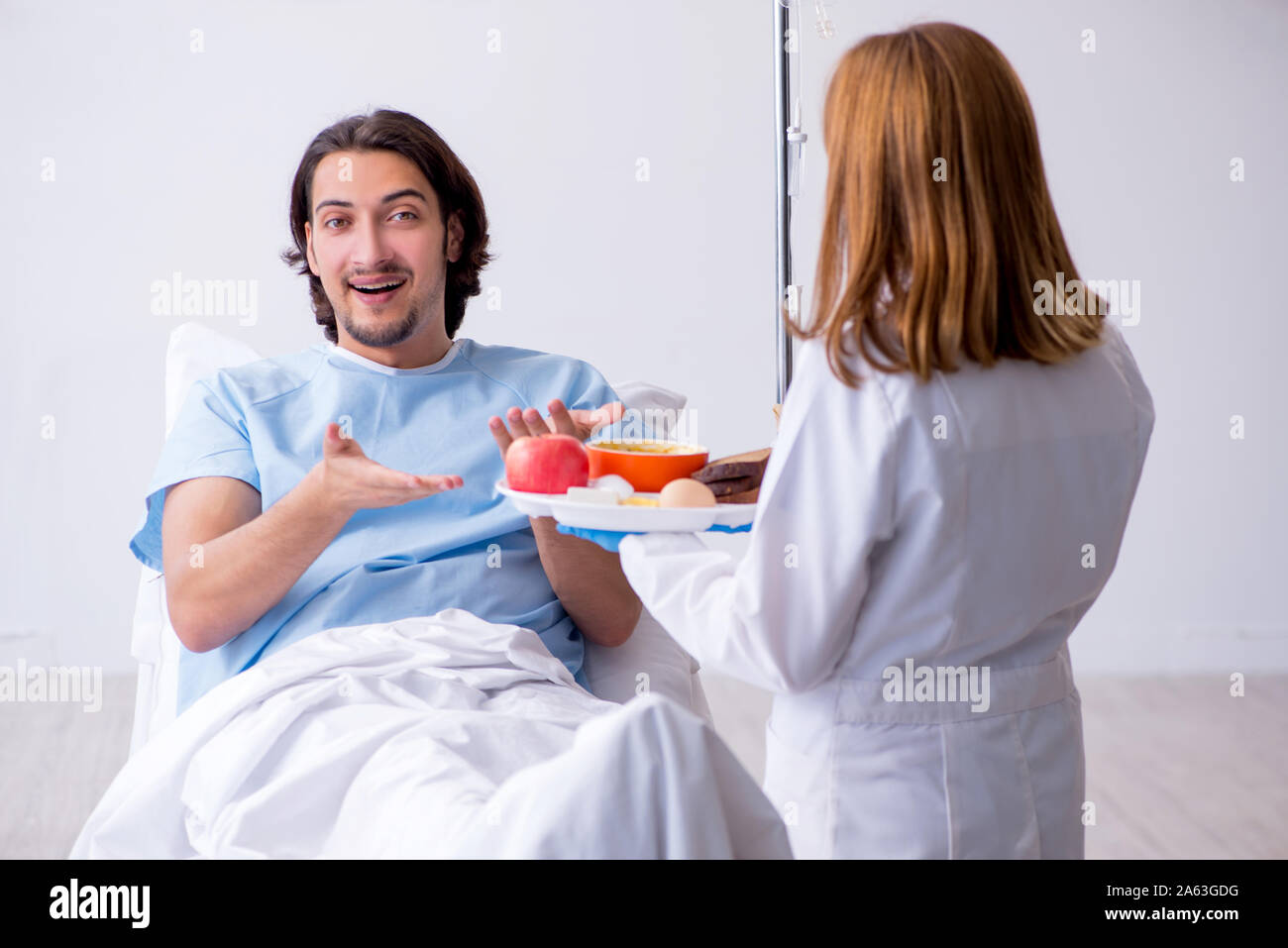 The male patient eating food in the hospital Stock Photo - Alamy