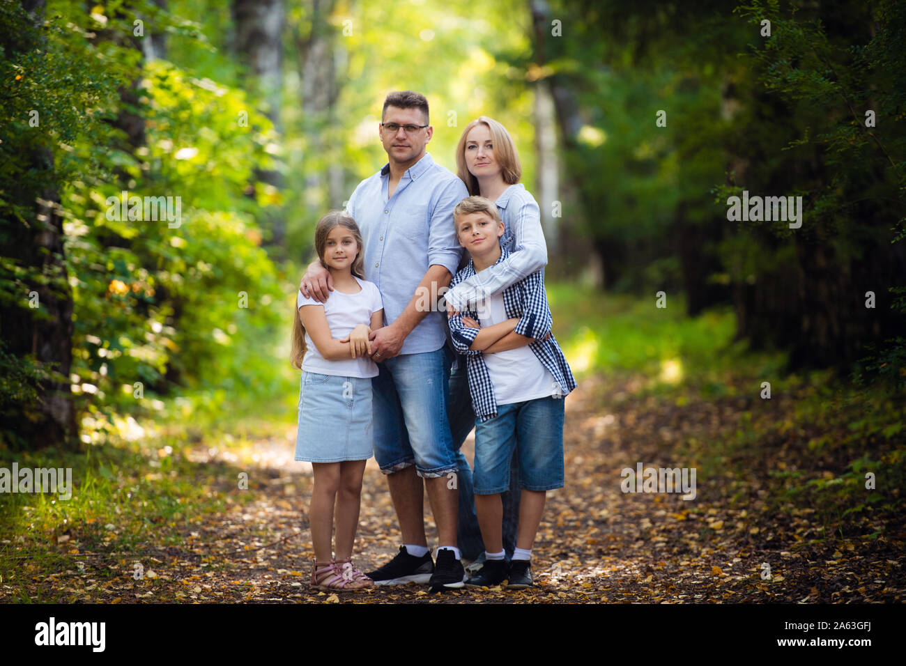 Family Group Standing Outdoors At Green Park In Autumn Landscape Stock ...