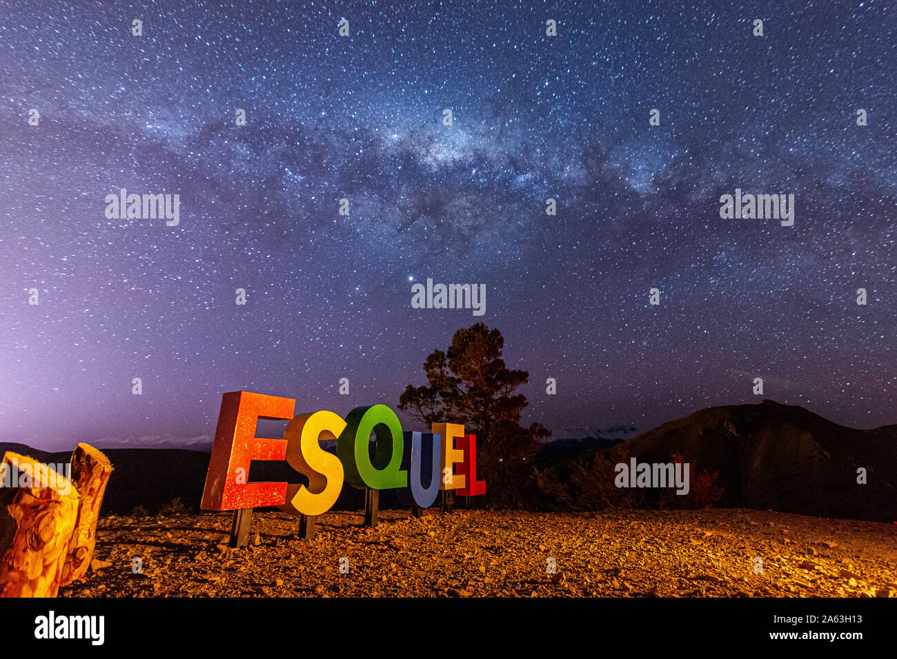 Night view of illuminated Esquel city sign beneath milky way during ...