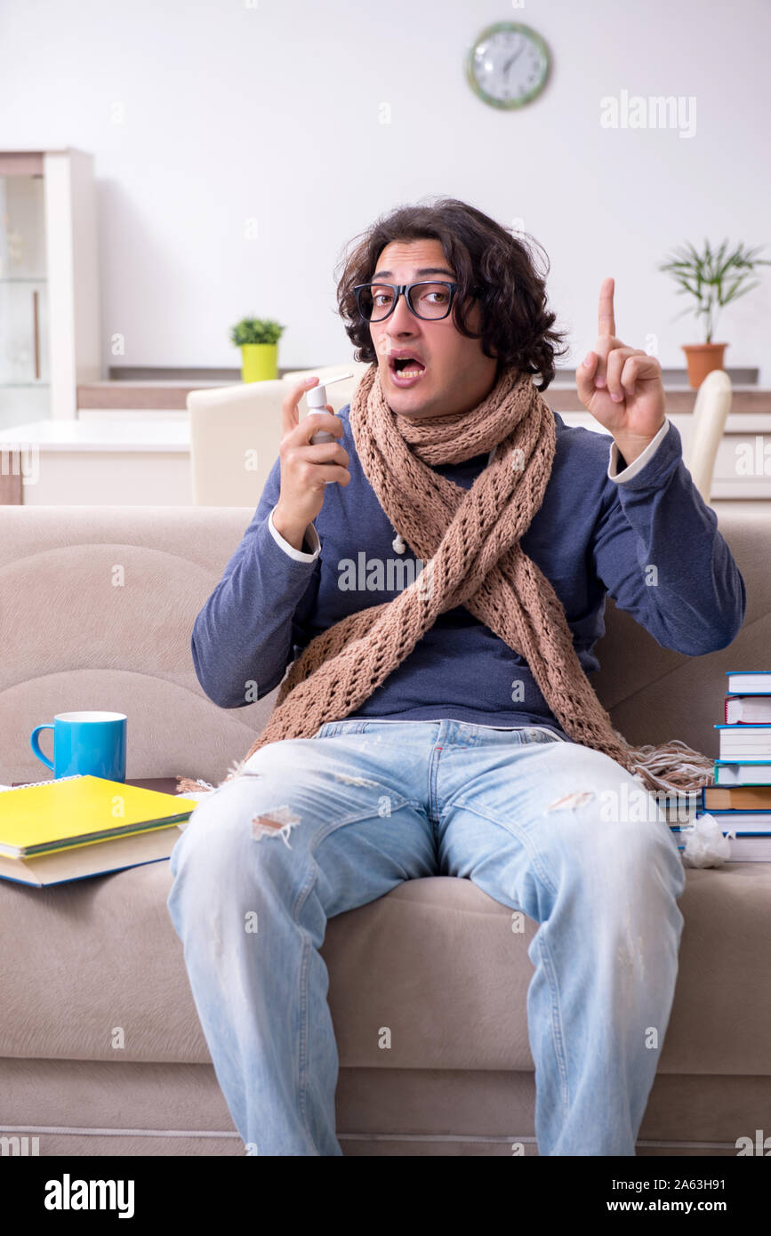 The sick male student suffering at home Stock Photo - Alamy