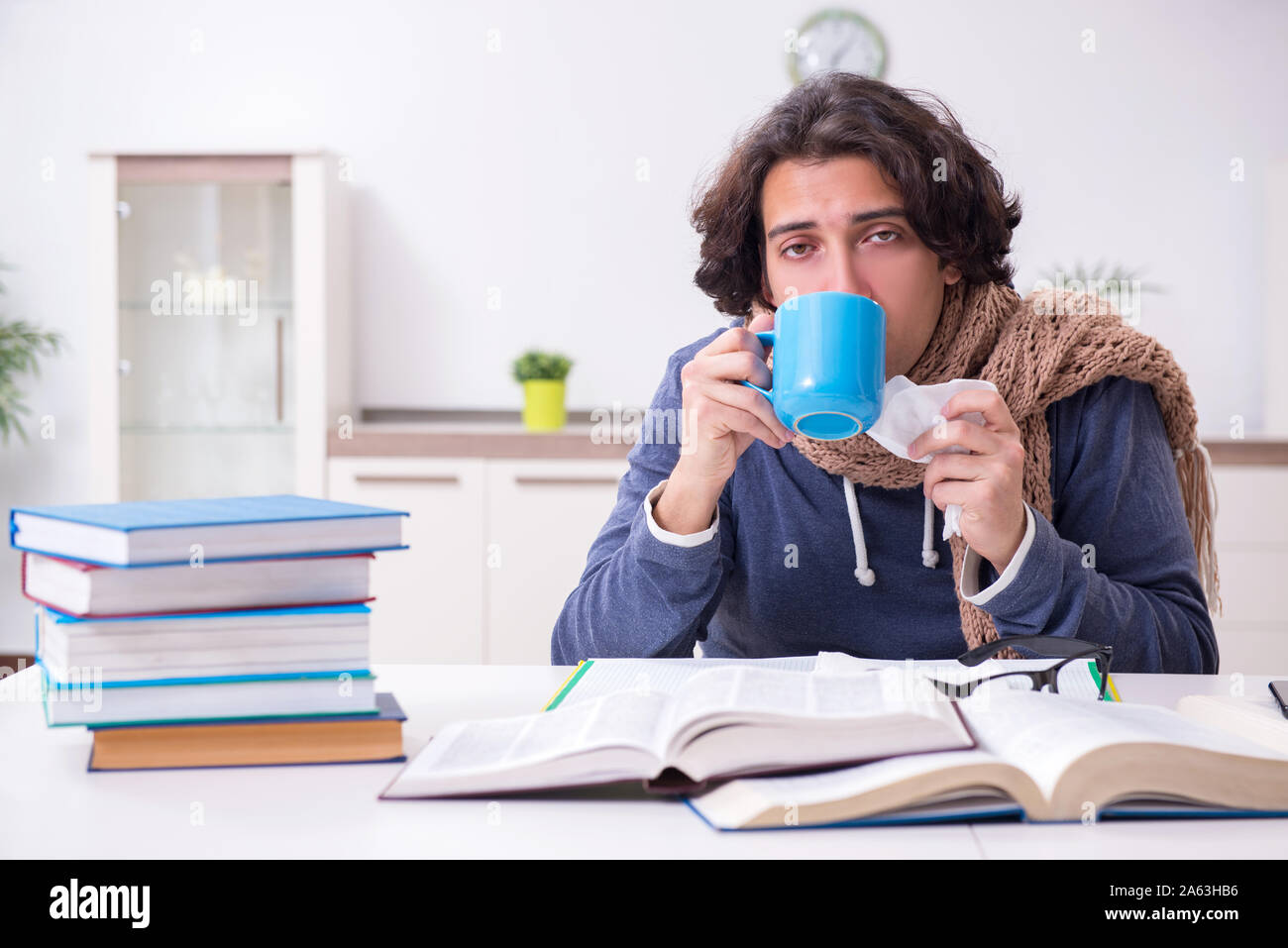 The sick male student suffering at home Stock Photo - Alamy