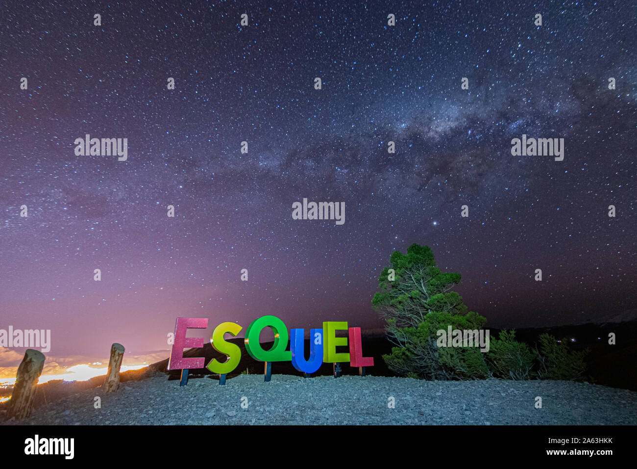 Night view of illuminated Esquel city sign beneath milky way during ...