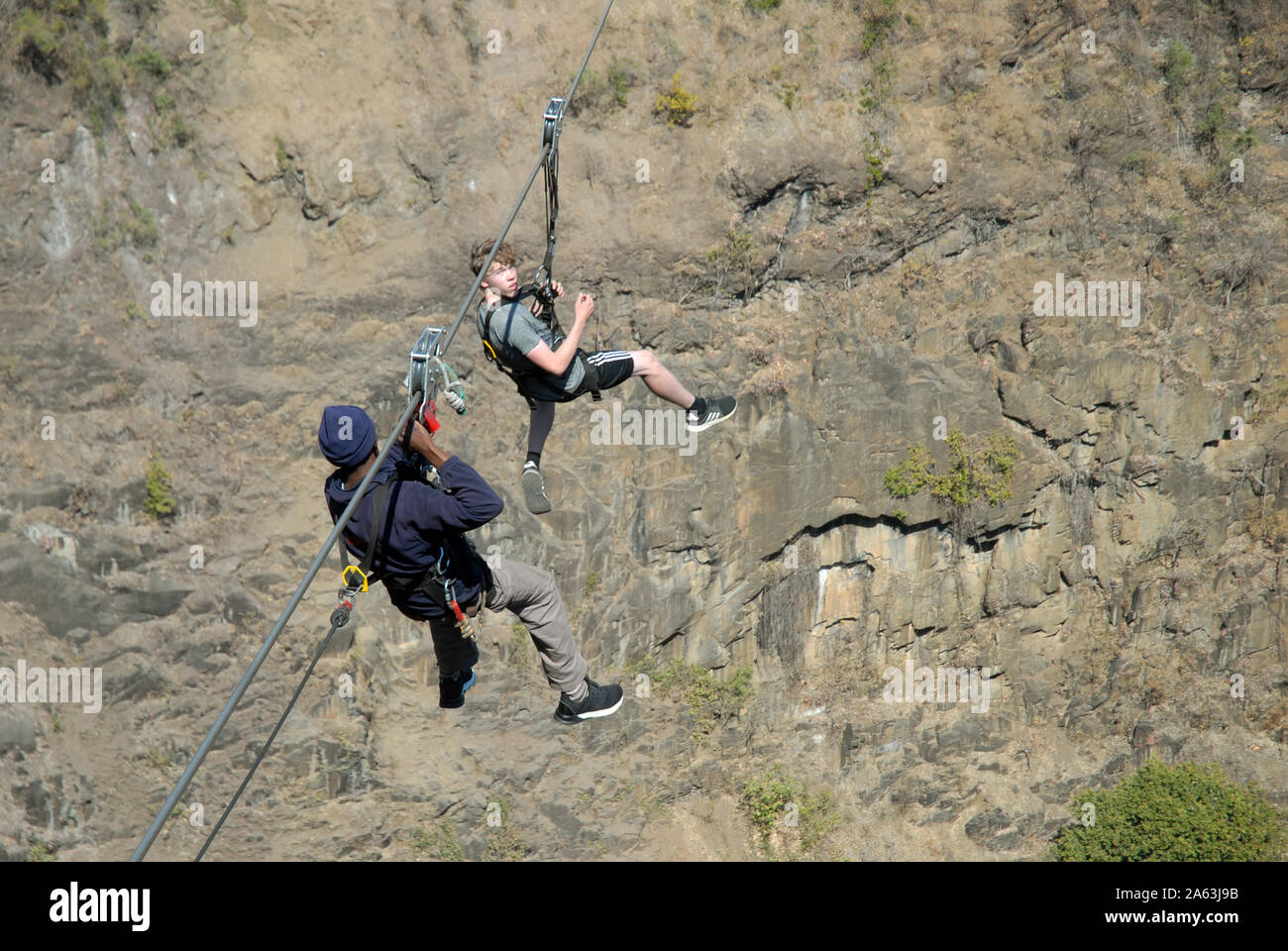 Zipline from the Victoria Falls Bridge over the Zambezi River, Zimbabwe ...