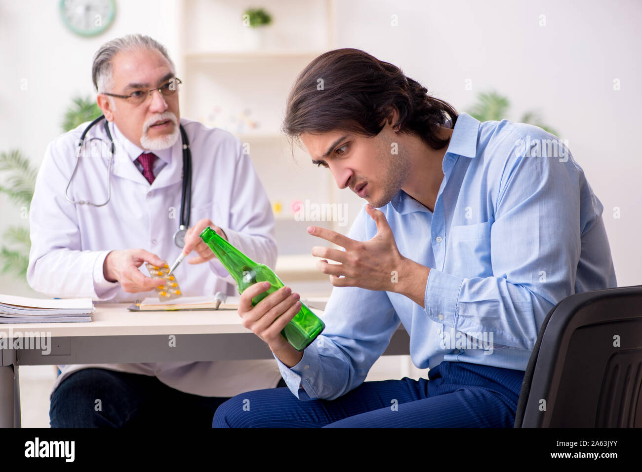 The young male alcoholic visiting old doctor Stock Photo - Alamy