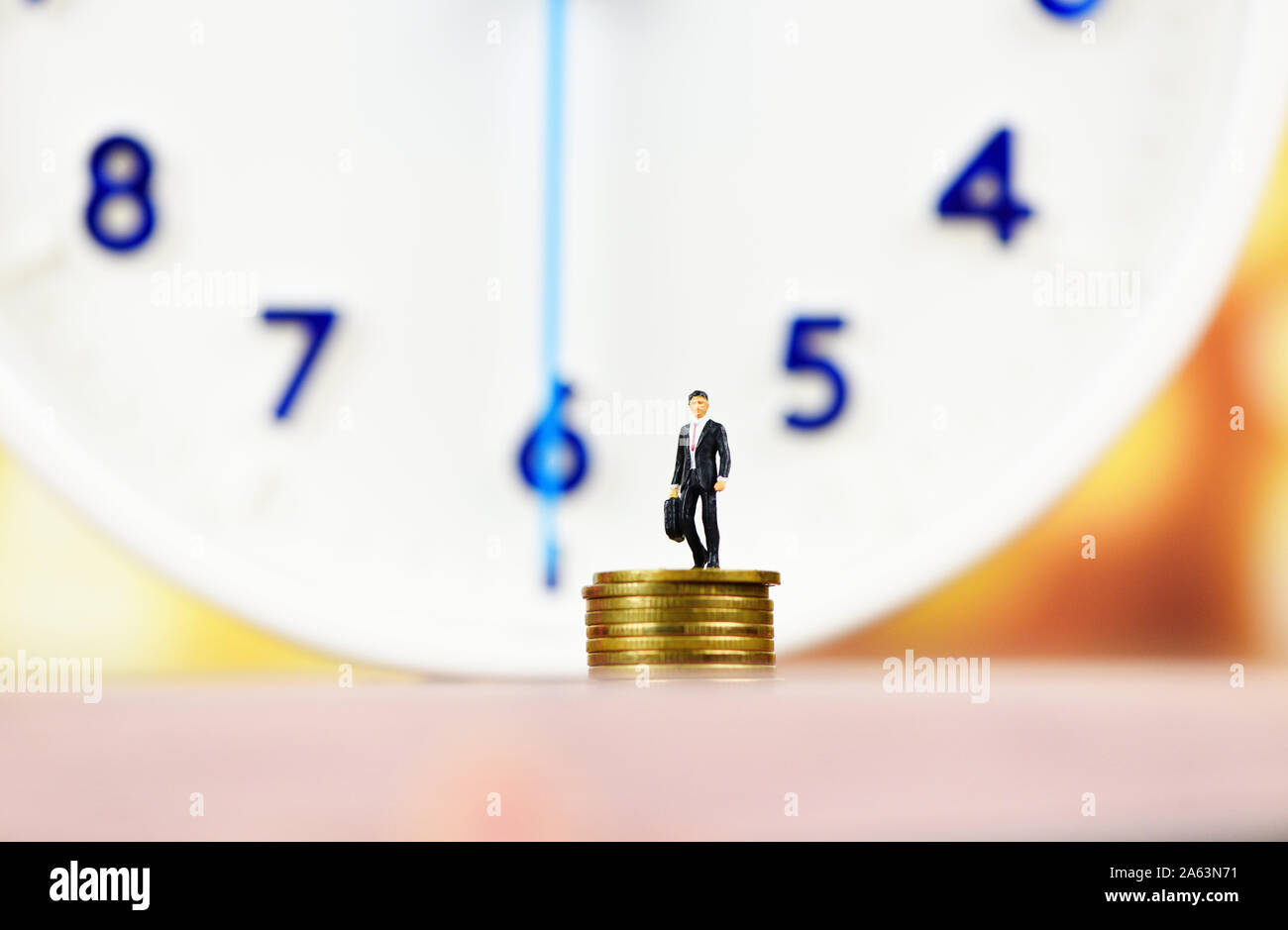 Time management with clocks background / Miniature business man ...